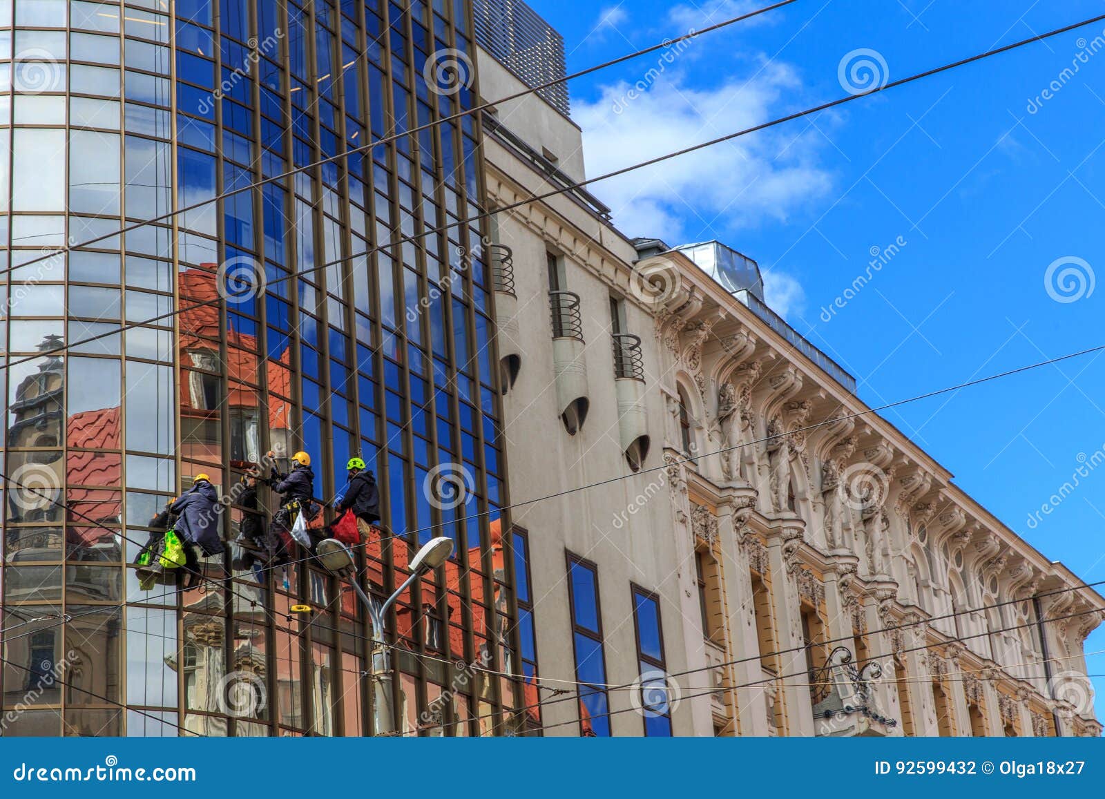 Washers Wash The Windows Of Modern Skyscraper. Window Cleaner Working ...