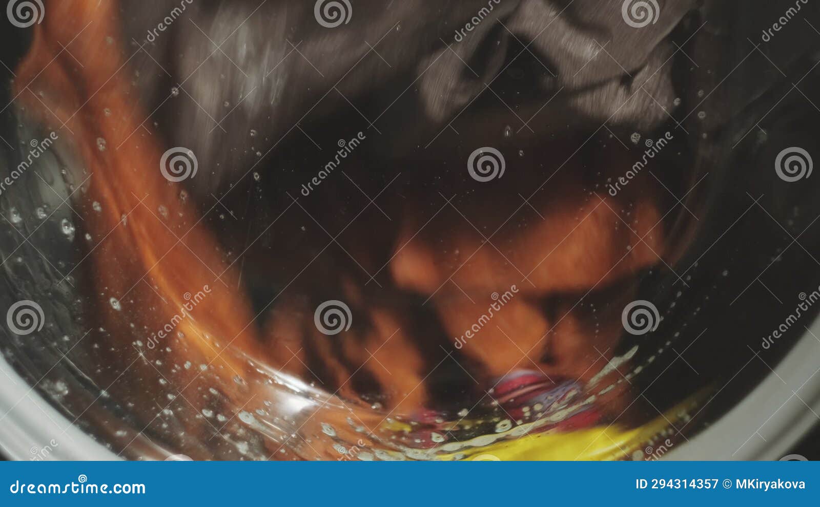 Close-up of Dirty Laundry Spinning Inside Washing Machine Drum. Laundry ...