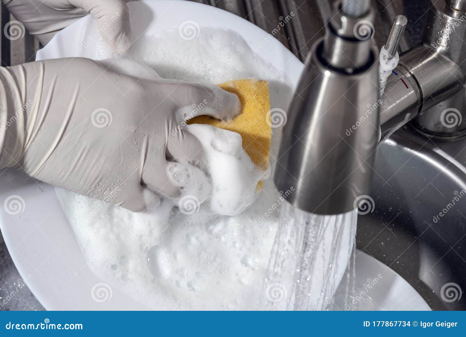 Washing Dishes with Foaming Detergent in a Kitchen Sink Stock Photo ...