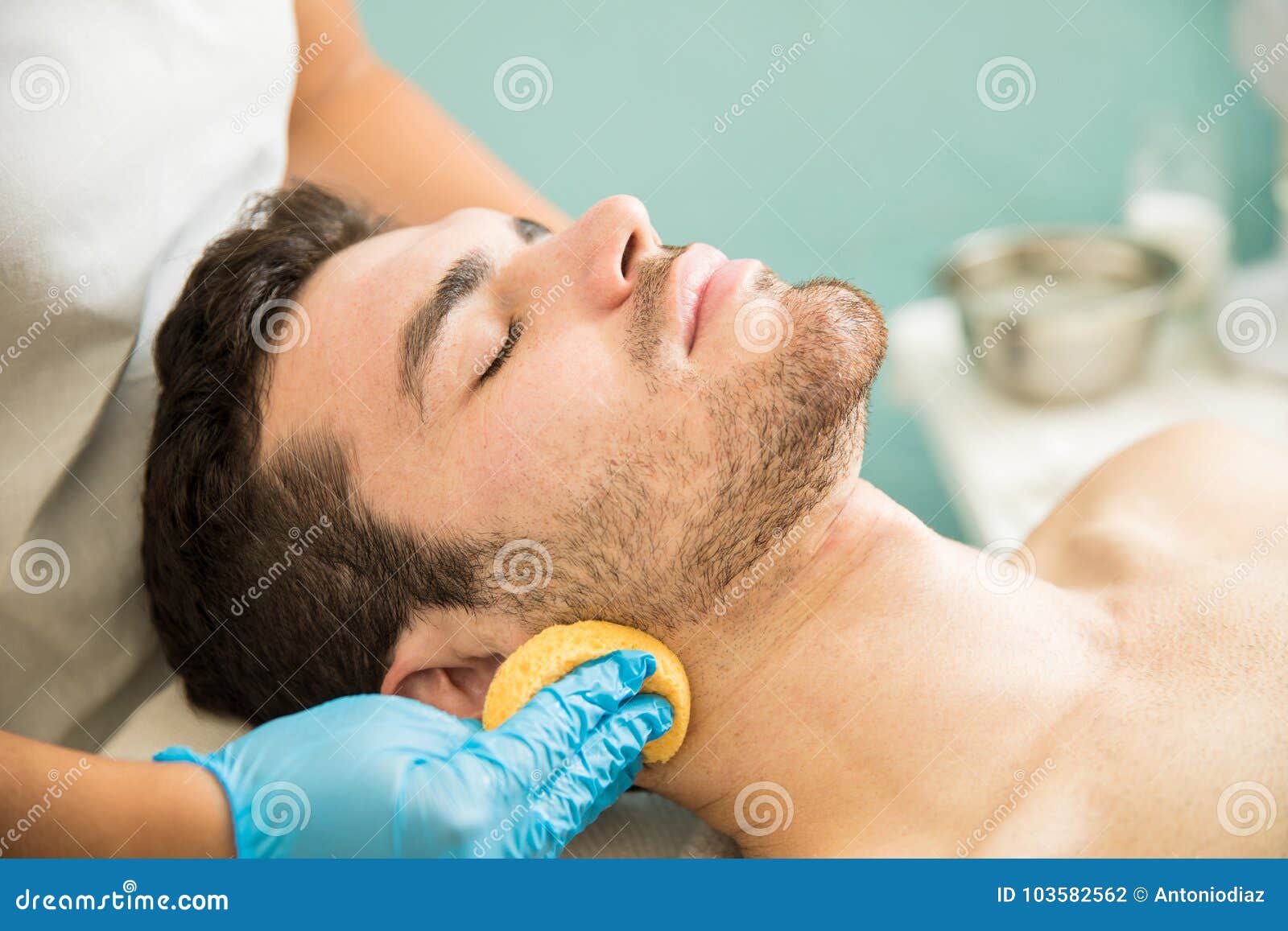 Washing face with a sponge stock photo. Image of closeup - 103582562