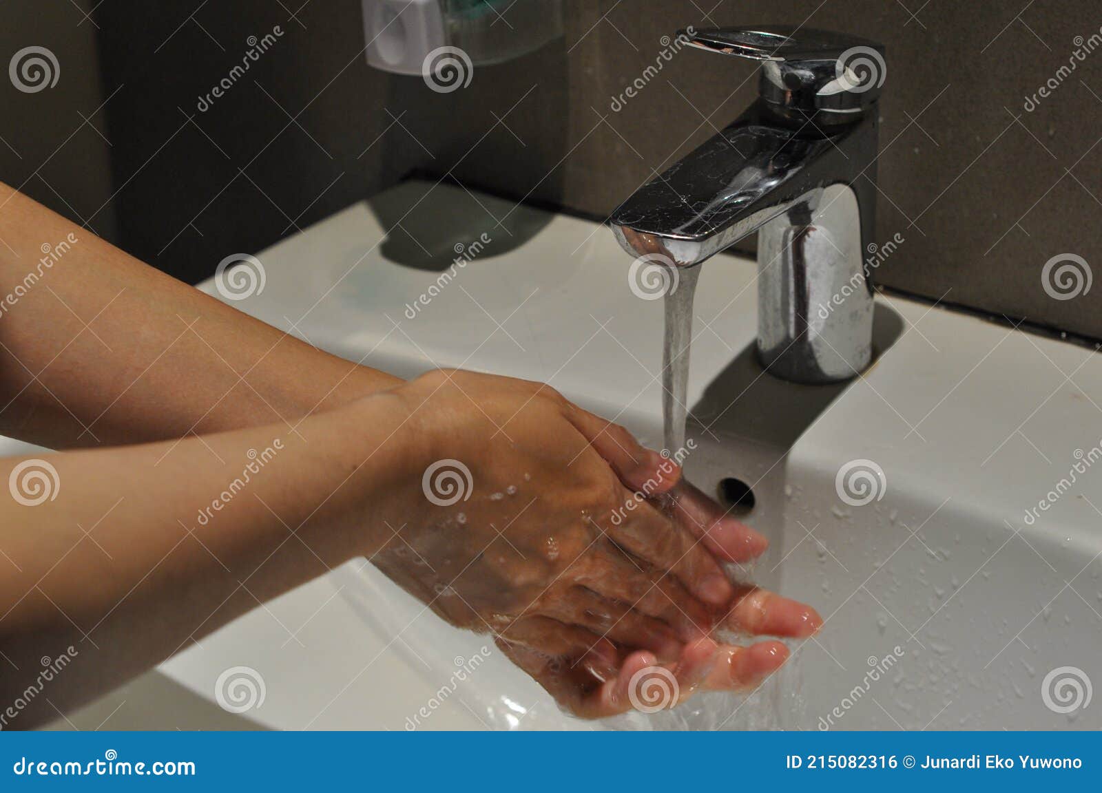 Washing hands in the sink stock photo. Image of hand - 215082316