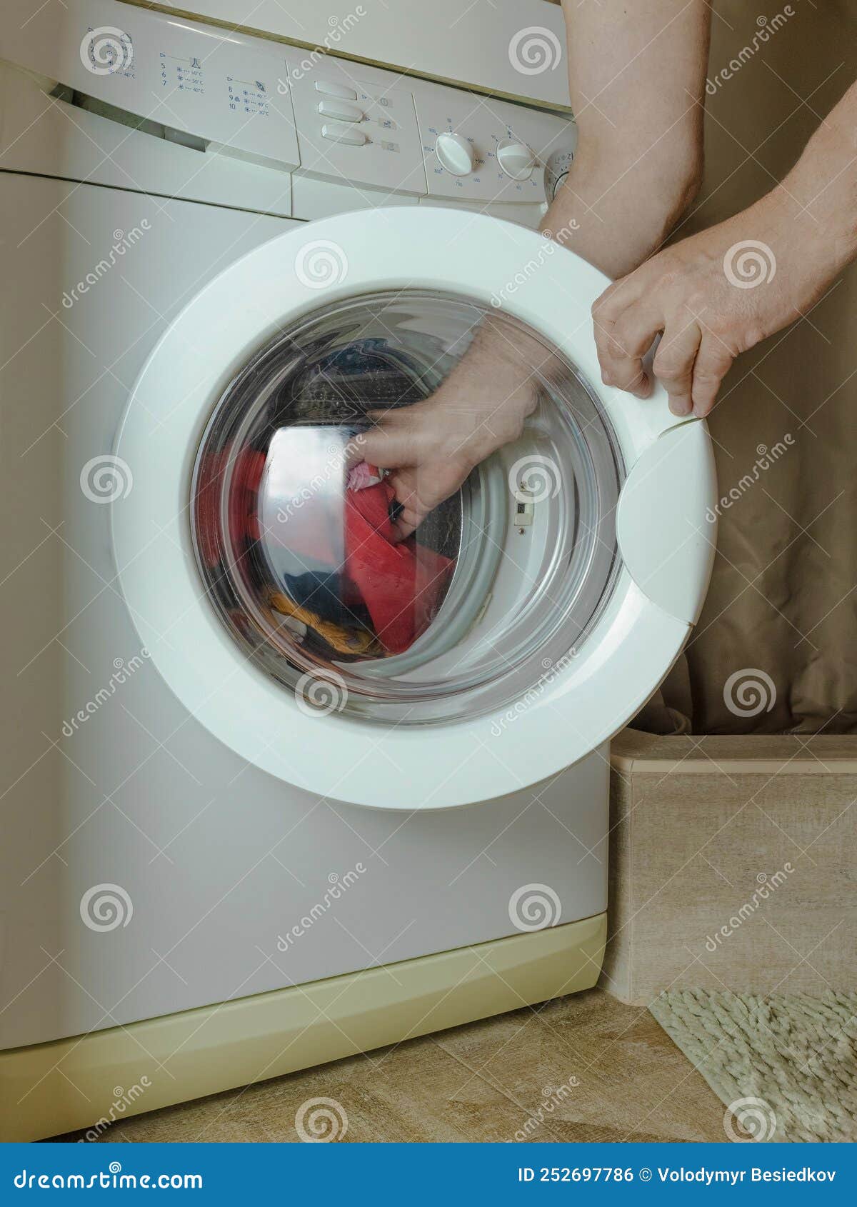 Loading the Washing Machine Stock Photo - Image of closeup, hand: 252697786