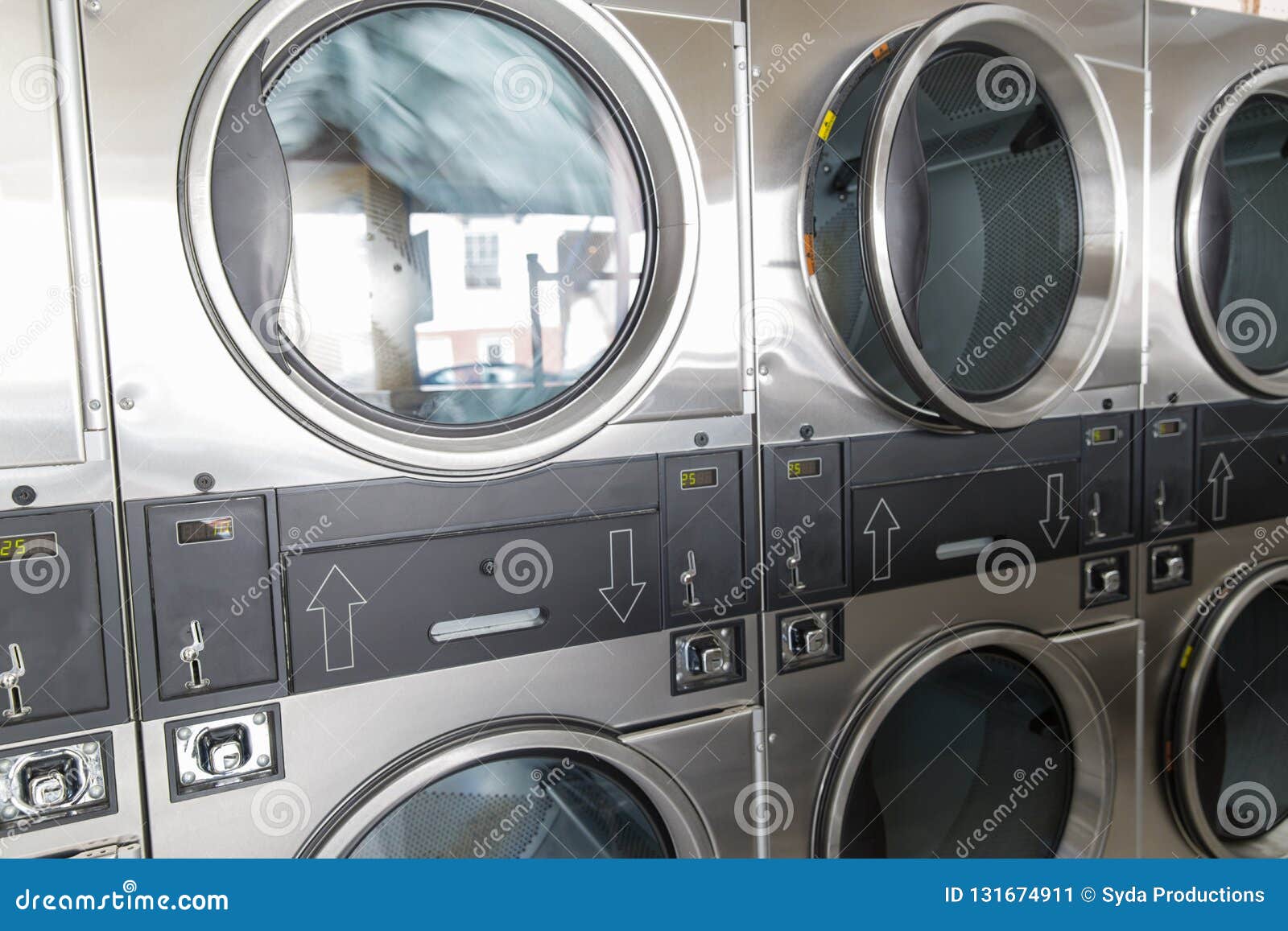 Washing Machines with Clothes Inside at Laundromat Stock Image - Image ...