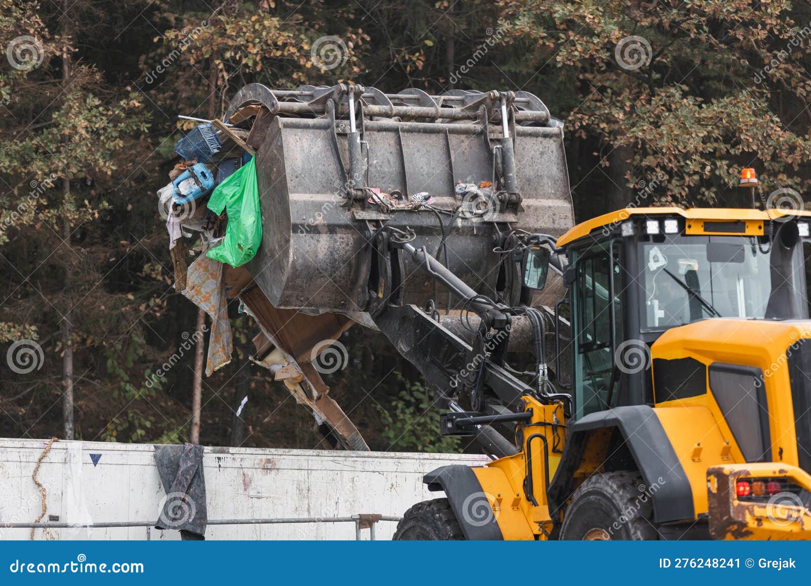 Waste Loading Operation, Loader Dumping Trash in a Truck Stock Image ...