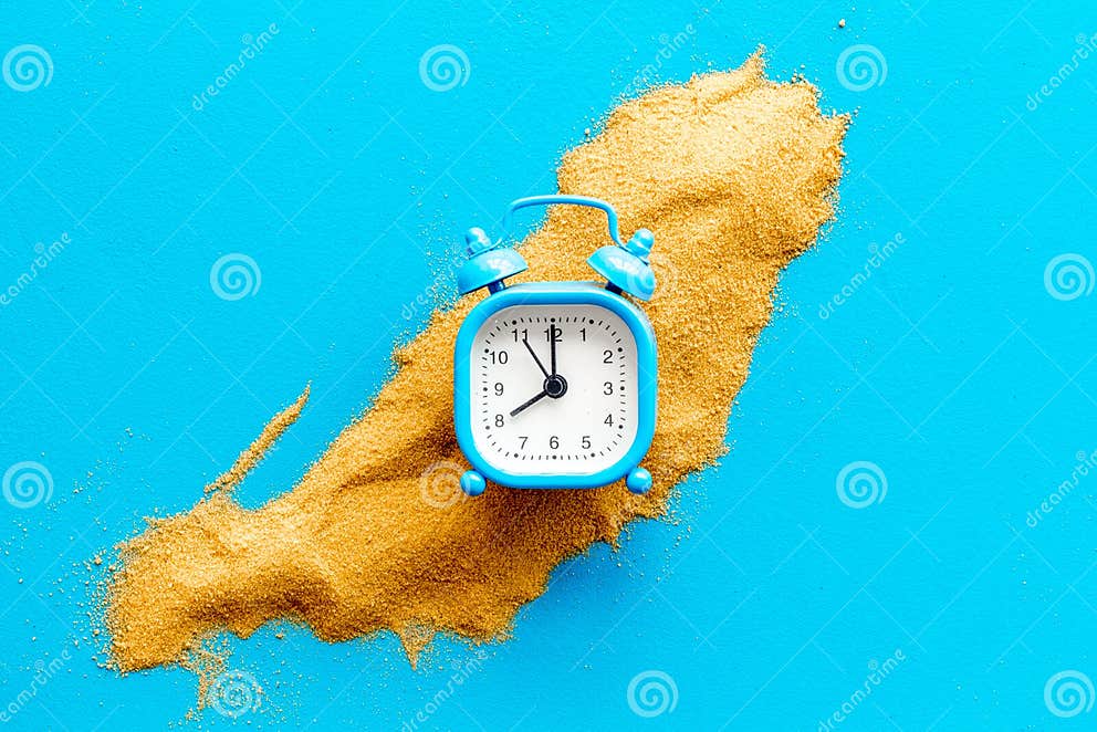 Waste of Time Concept. Clock on Sand on Blue Background Top-down Copy ...