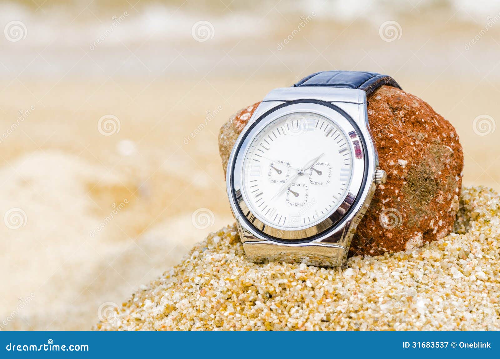 Watch in Sand stock image. Image of coast, passing, rock - 31683537