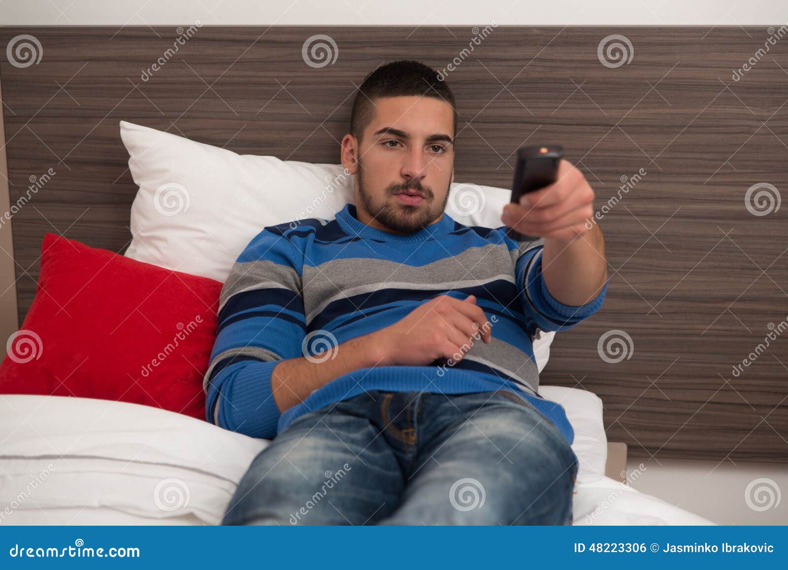 Watching Tv and Using Remote Control Stock Photo - Image of handsome ...