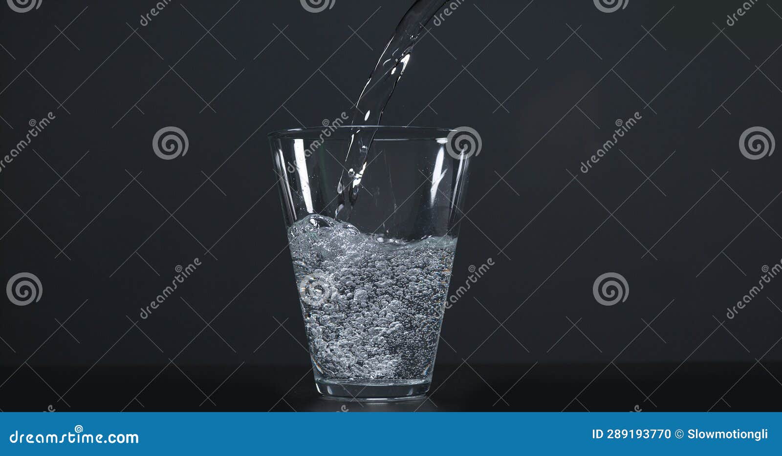 Water Being Poured into Glass Against Black Background Stock Photo ...