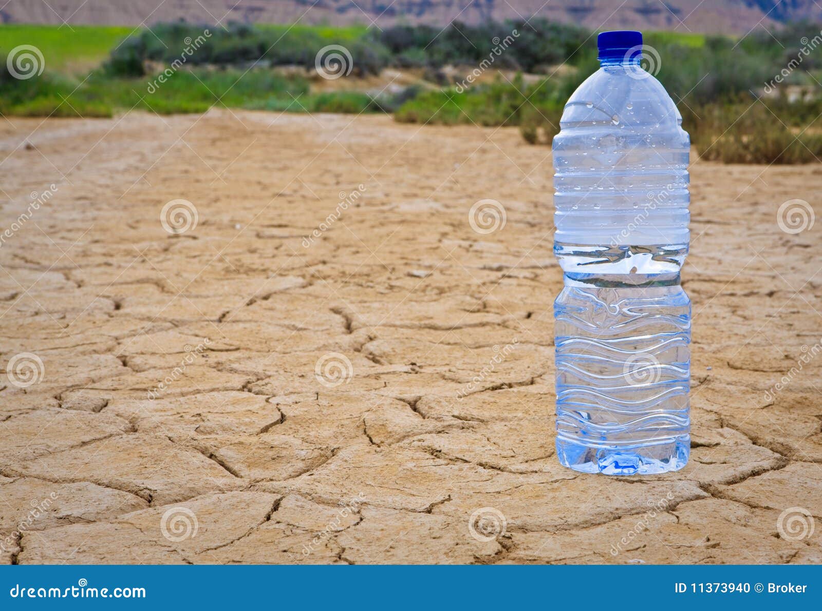 Water bottle on dry ground stock photo. Image of dehydrated - 11373940