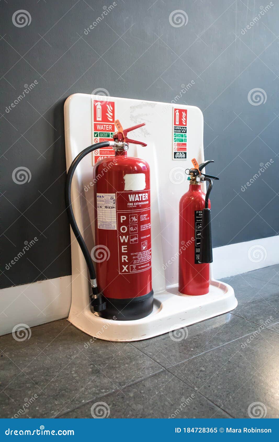 Water and Carbon Dioxide Fire Extinguishers at a Fire Station by a Wall ...