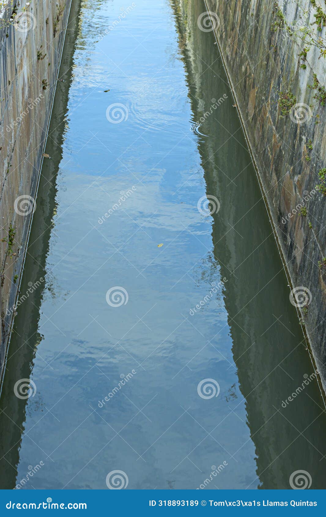 A Water Channel through Stone Walls Reflecting the Sky on the Surface ...