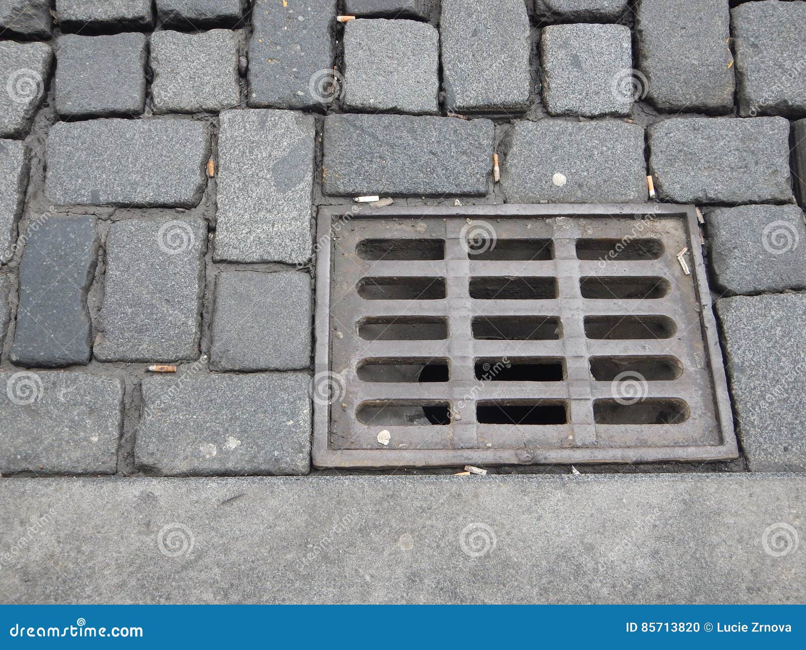 Water Drainage Hole with Grid on a Cobbled Street Stock Photo - Image ...