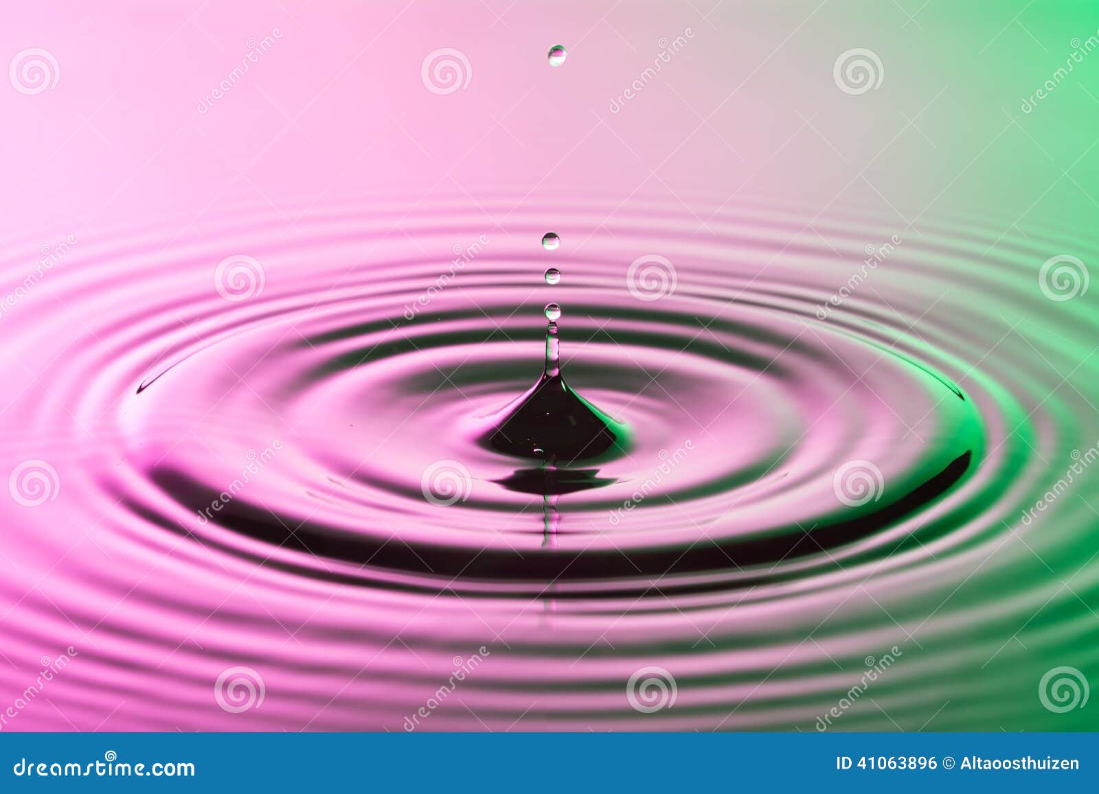 Water Drop Close with Concentric Ripples on Colourful Pink and Green ...