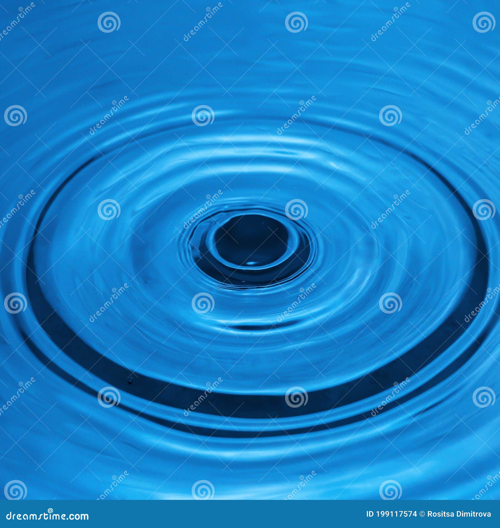 Water Drop Falling into Water Making a Perfect Droplet Splash in Blue ...