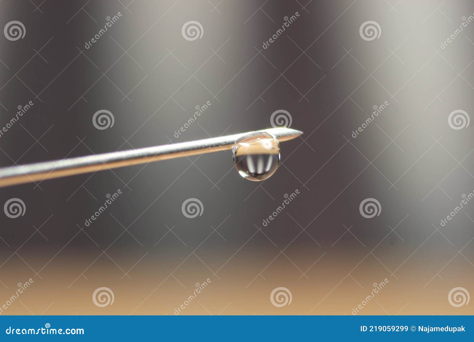 Water Drop Falling from the Syringe Needle Against Grey Background ...