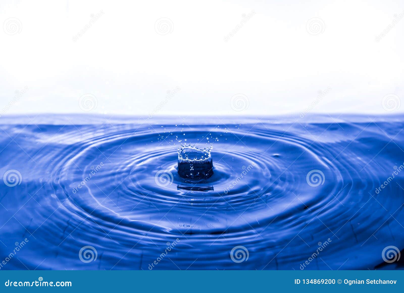 Water Drop Falling into Water Making a Concentric Circles Stock Photo ...