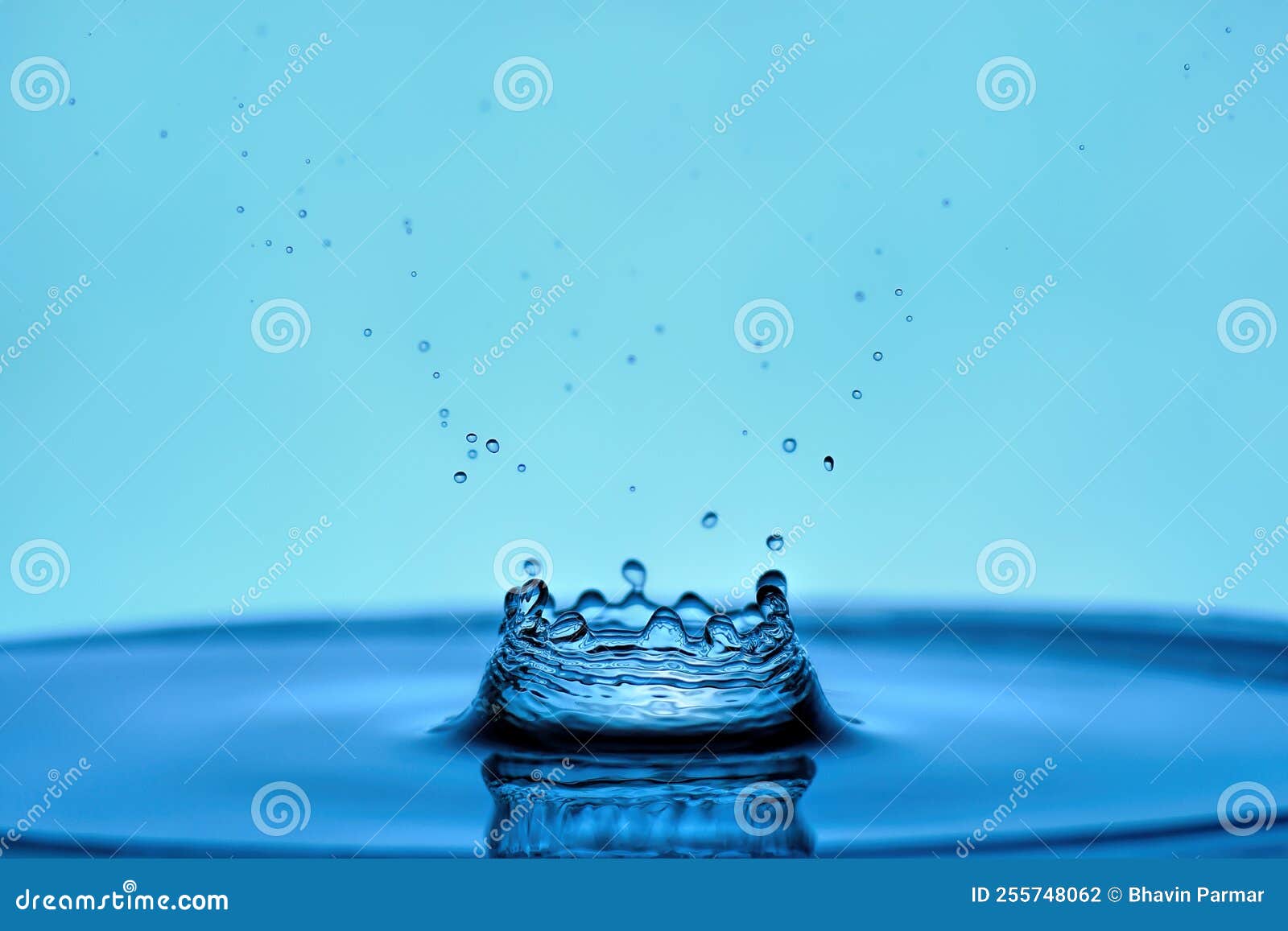 Water Drop Splash. Water Drop in Blue Background. Stock Photo - Image ...