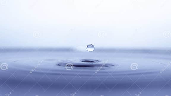 Water Drop Splash in a Glass Blue Colored Stock Image - Image of ...