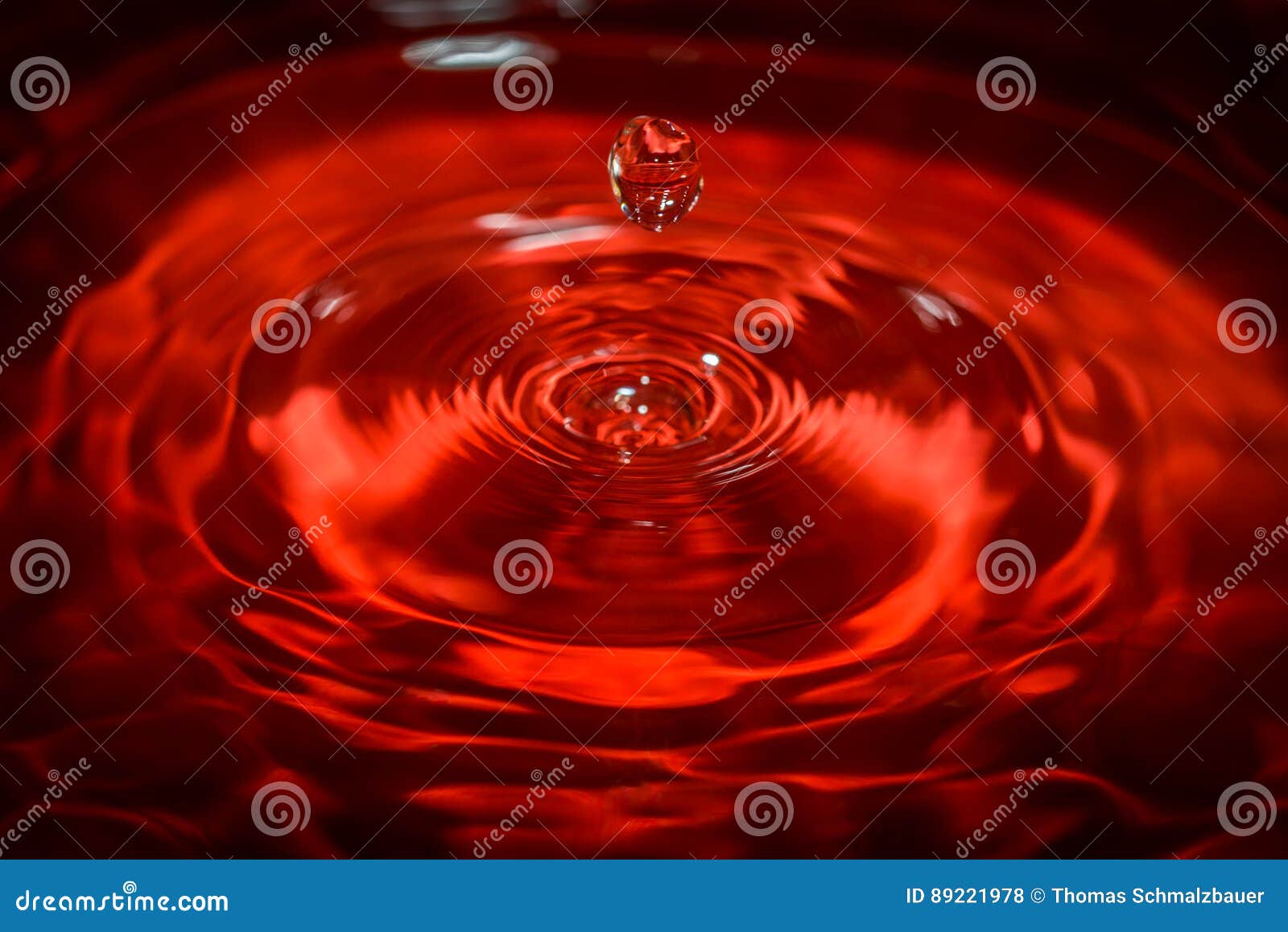 Water Drop an Waves with Red Background and Reflection Stock Photo ...