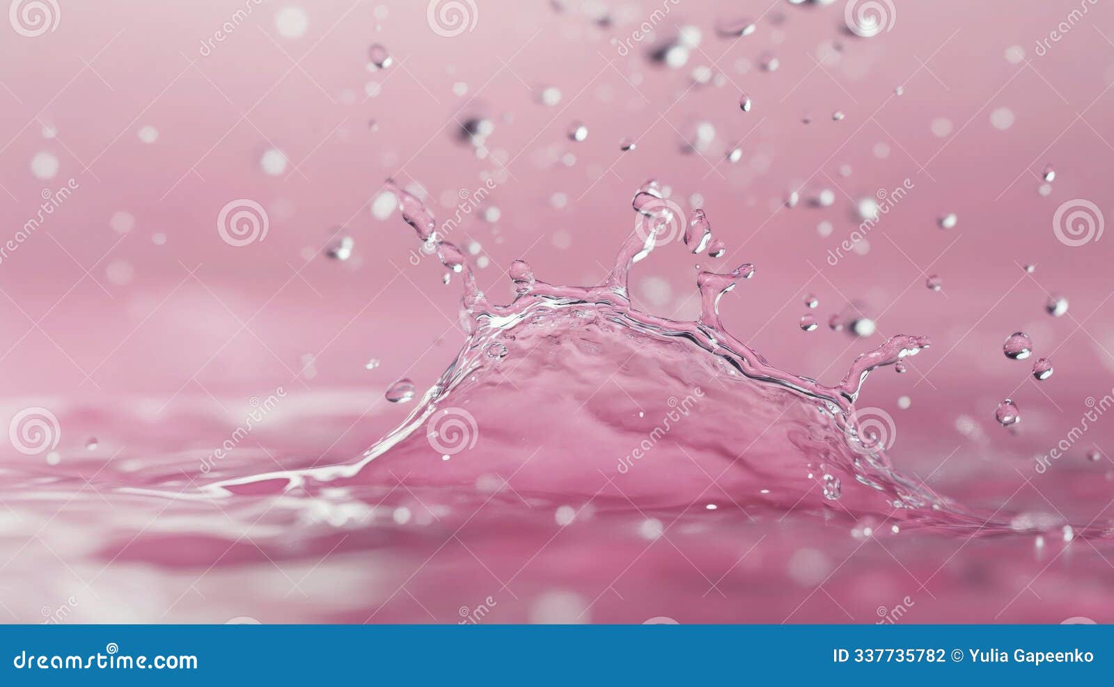 Water Droplet Splash Creating Ripples in a Soft Pink Background during ...