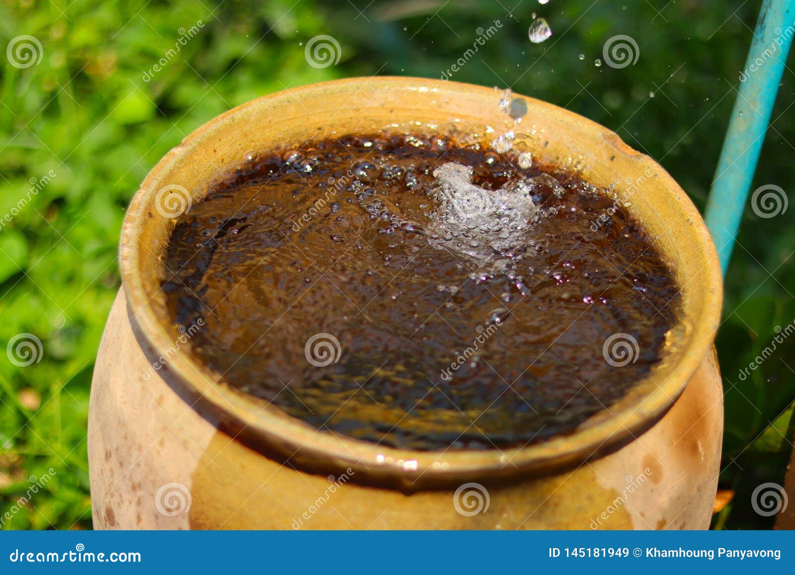 Water Dropping from Leaking Water Tap into Vintage Earthenware Jar ...