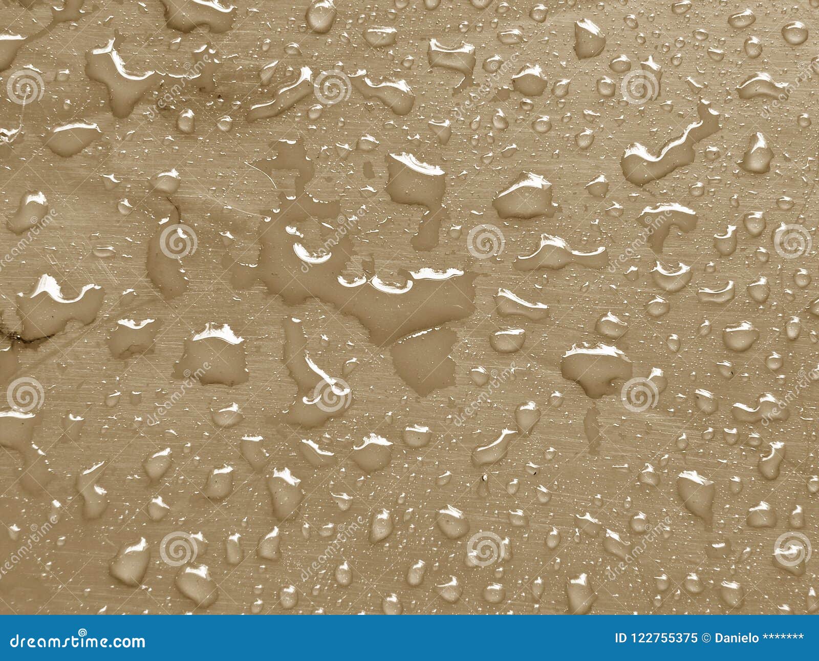 Water Drops on Almond Buff Colored Metallic Surface Stock Image - Image ...