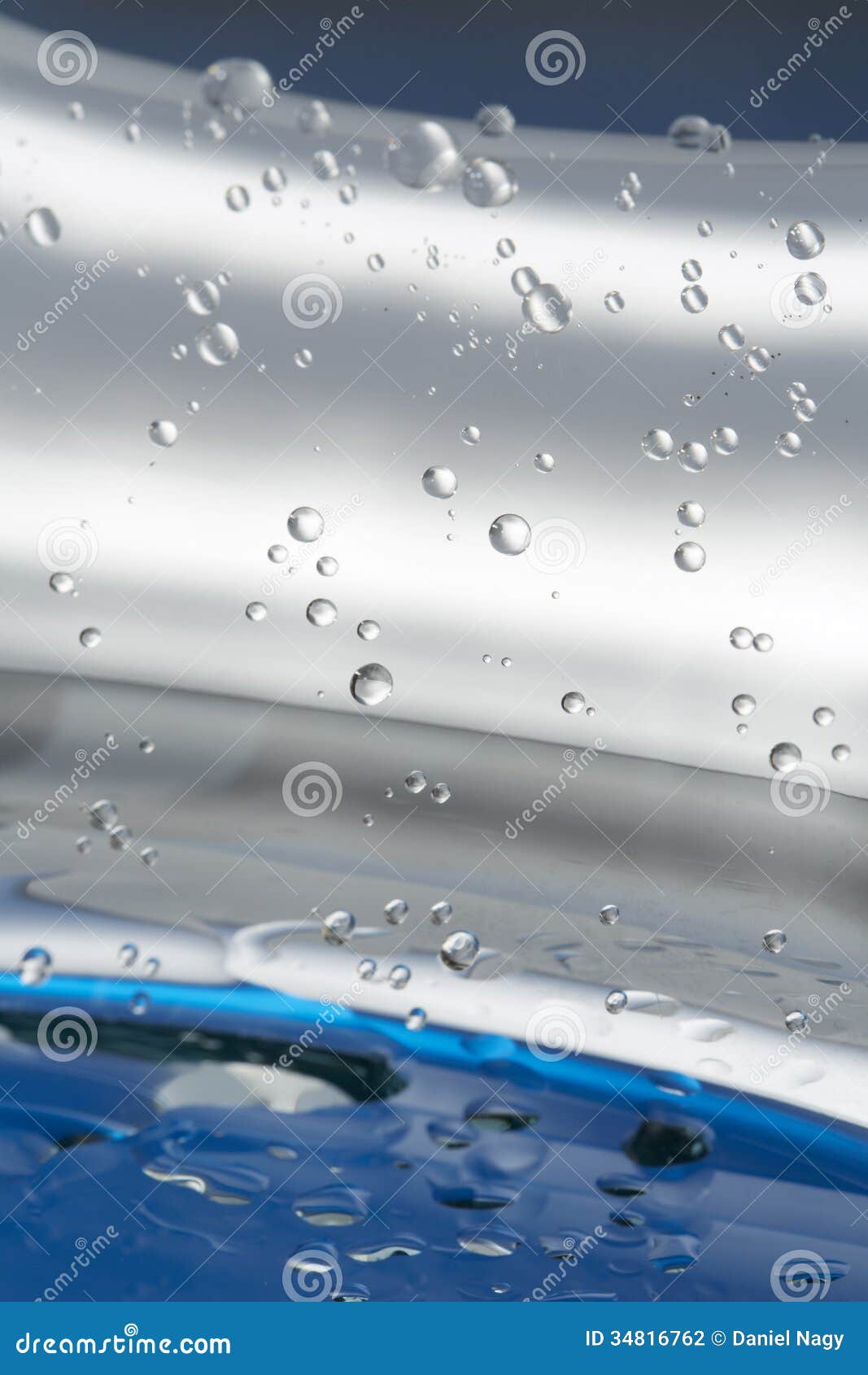 Water Drops on a Silver Metallic Surface with Blue Background Stock ...