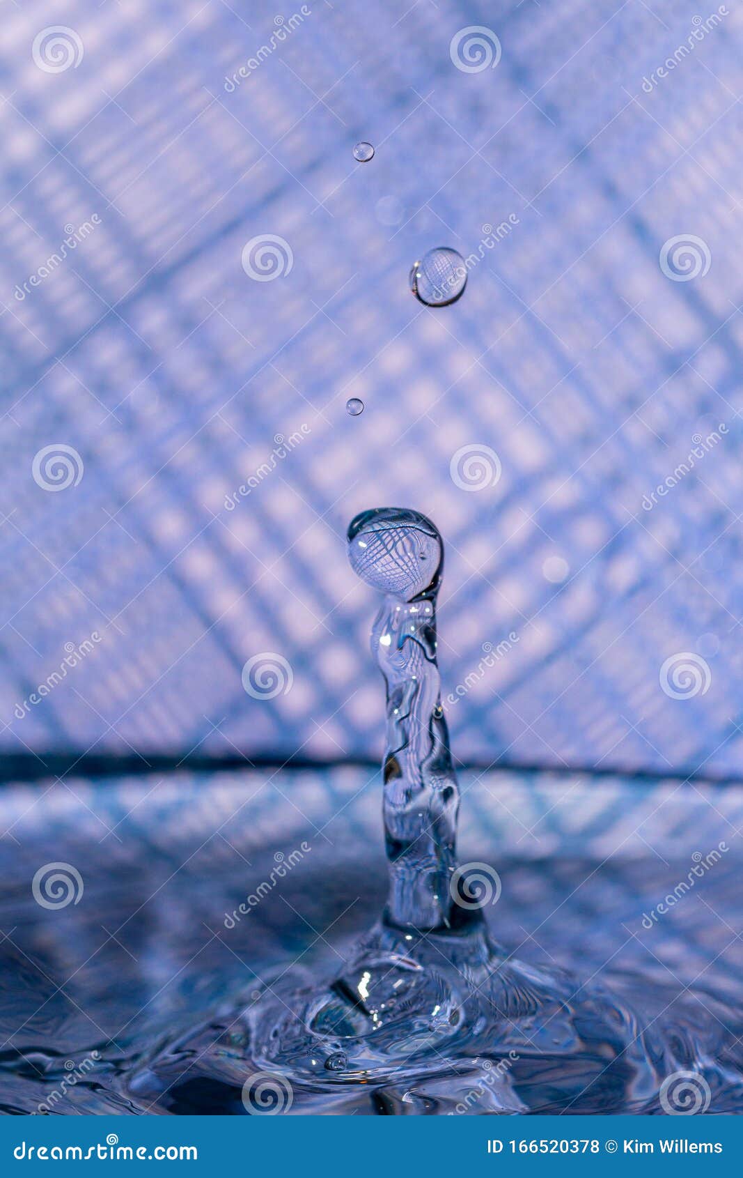 Water Drops Splashing in Front of a Blue Striped Background with ...