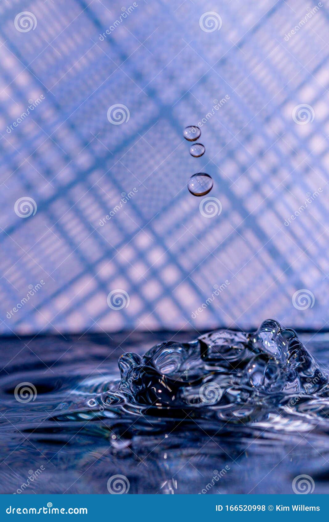 Water Drops Splashing in Front of a Blue Striped Background with ...