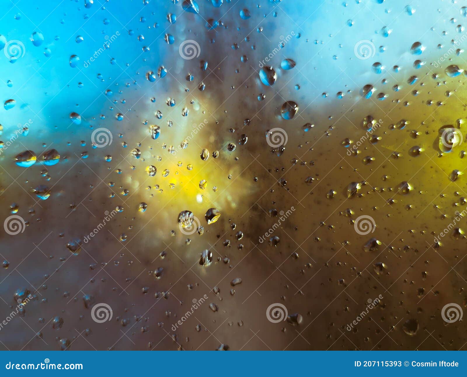 Water Drops on a Steamy Window with Yellow and Blue Abstract Background ...