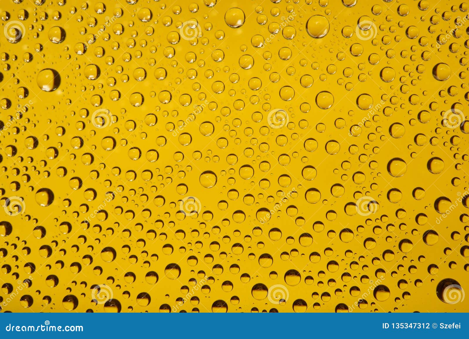Water drops in yellow stock photo. Image of abstract - 135347312