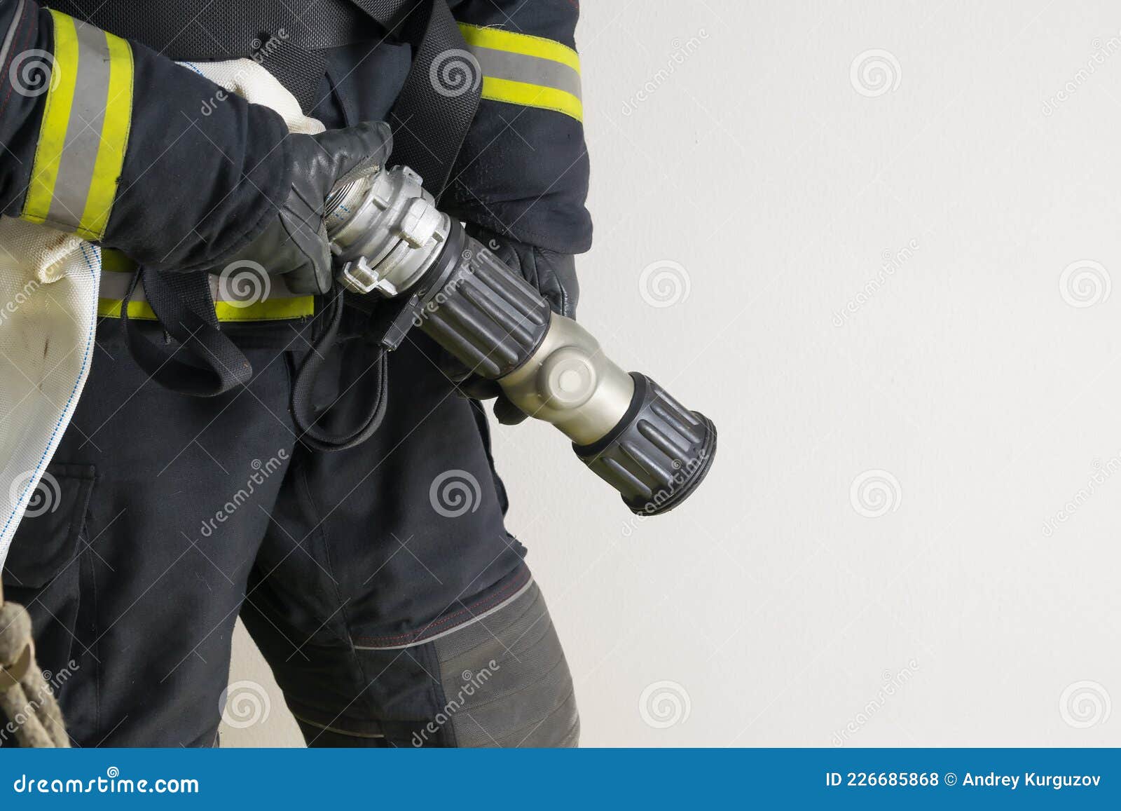 Water Equipment for Extinguishing a Fire in the Hands of a Firefighter ...