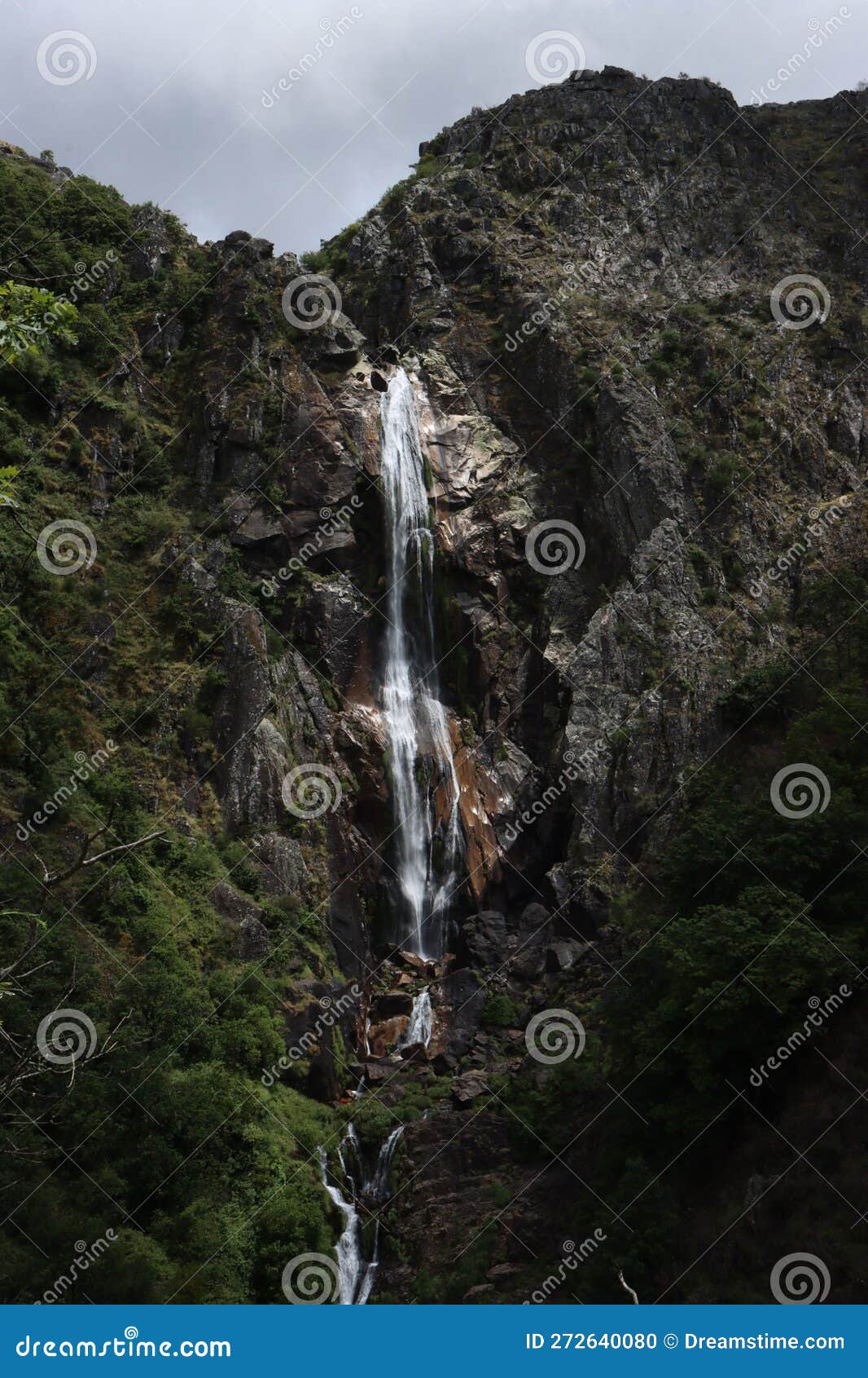 A Water Fall in the Mountains with Some Trees on Either Side Stock ...