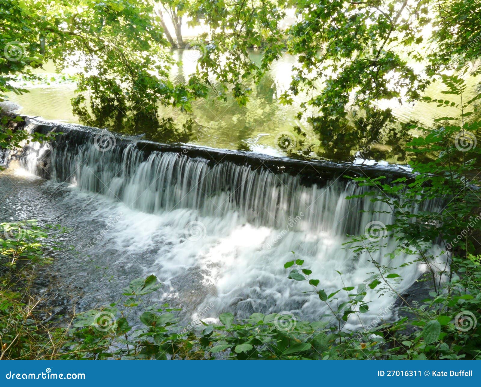 Water falling over a weir stock image. Image of waterfall - 27016311