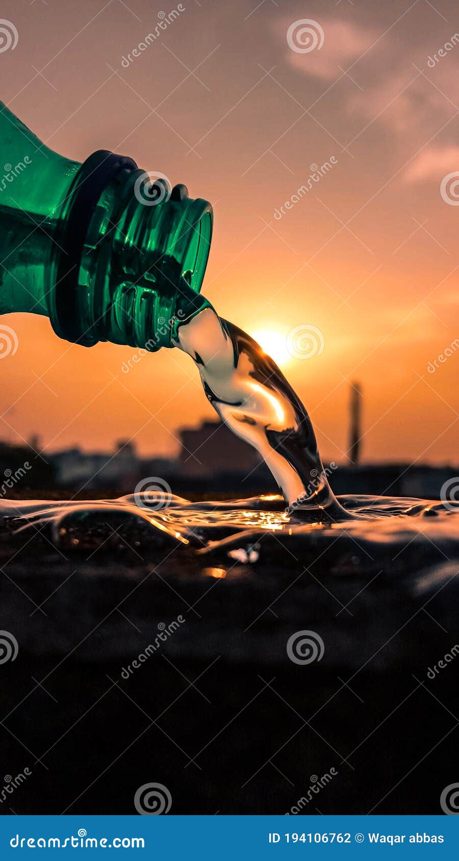 Water Falling Throw the Bottle at the Time of Sunset. Stock Photo ...