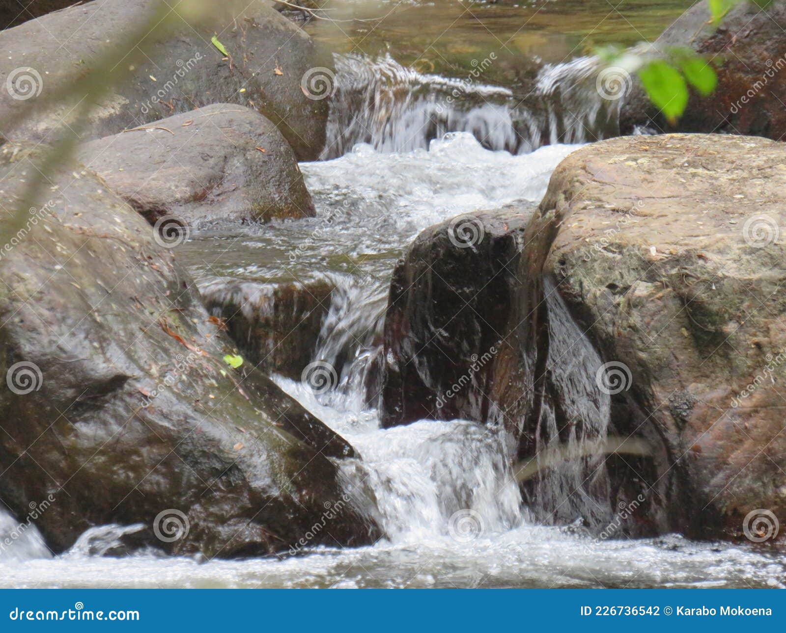 Water flow between rocks stock photo. Image of natural - 226736542