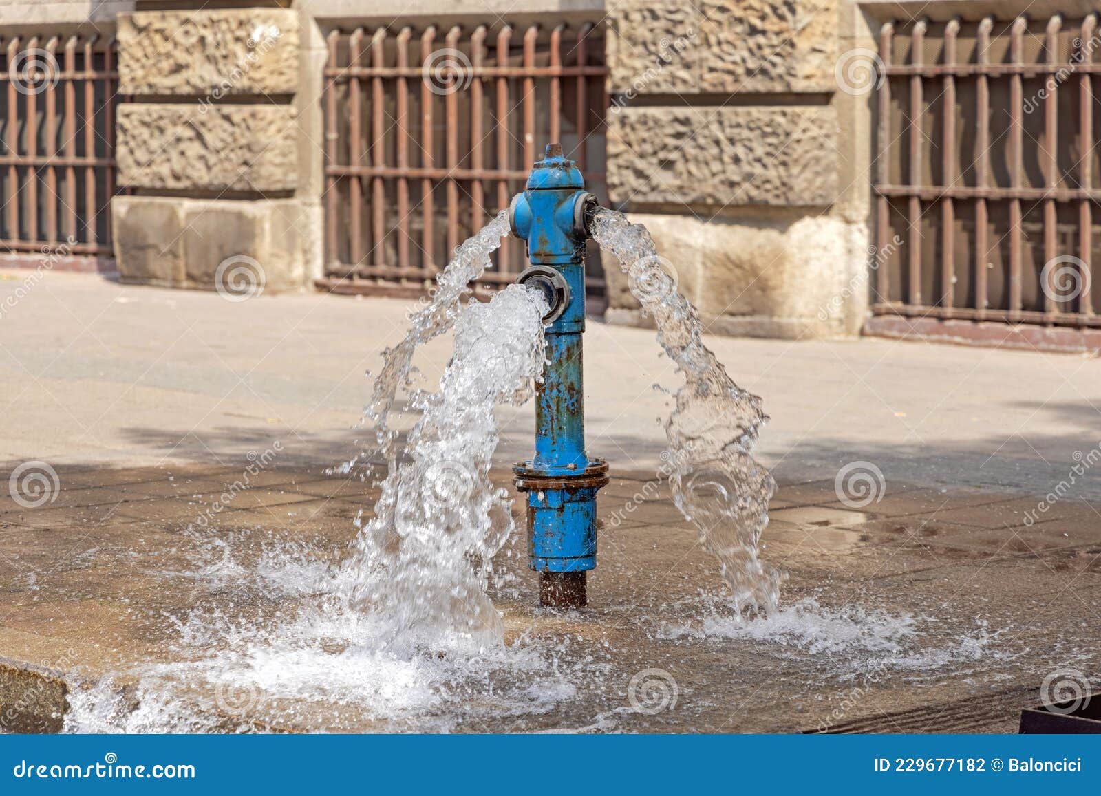 Open Water Hydrant stock photo. Image of pavement, street - 229677182
