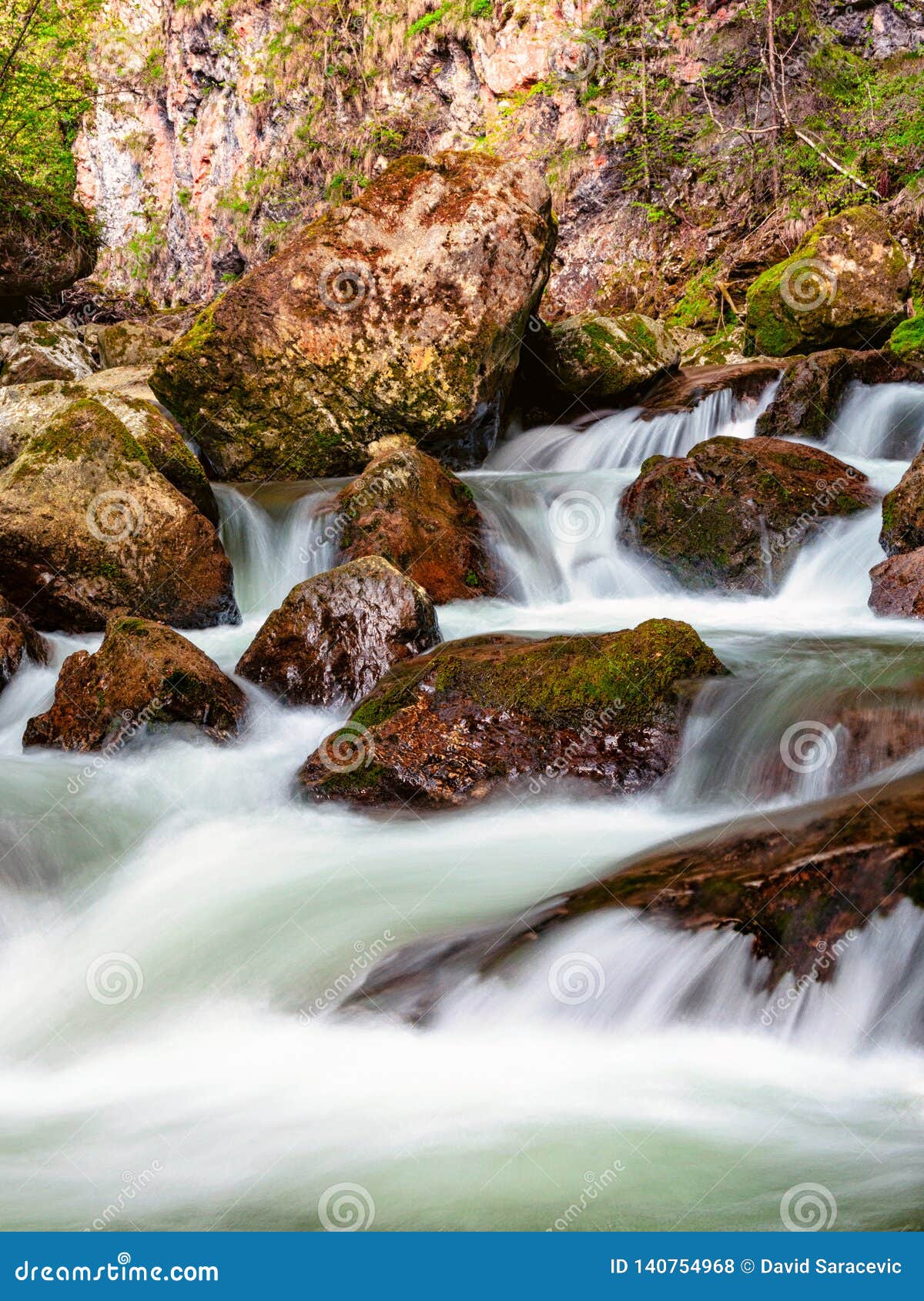 Water flowing around rocks stock photo. Image of tranquil - 140754968