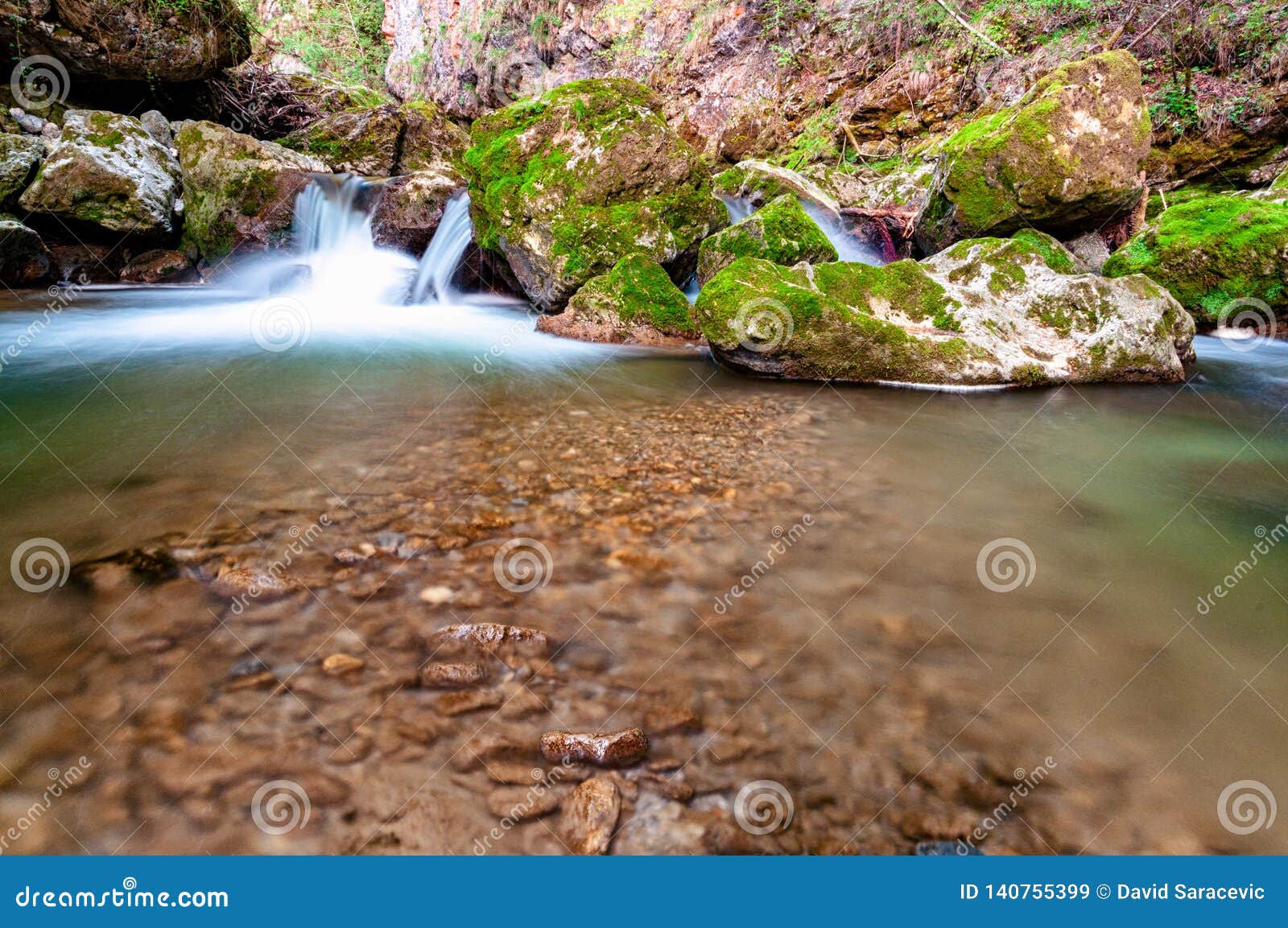 Water flowing around rocks stock image. Image of white - 140755399