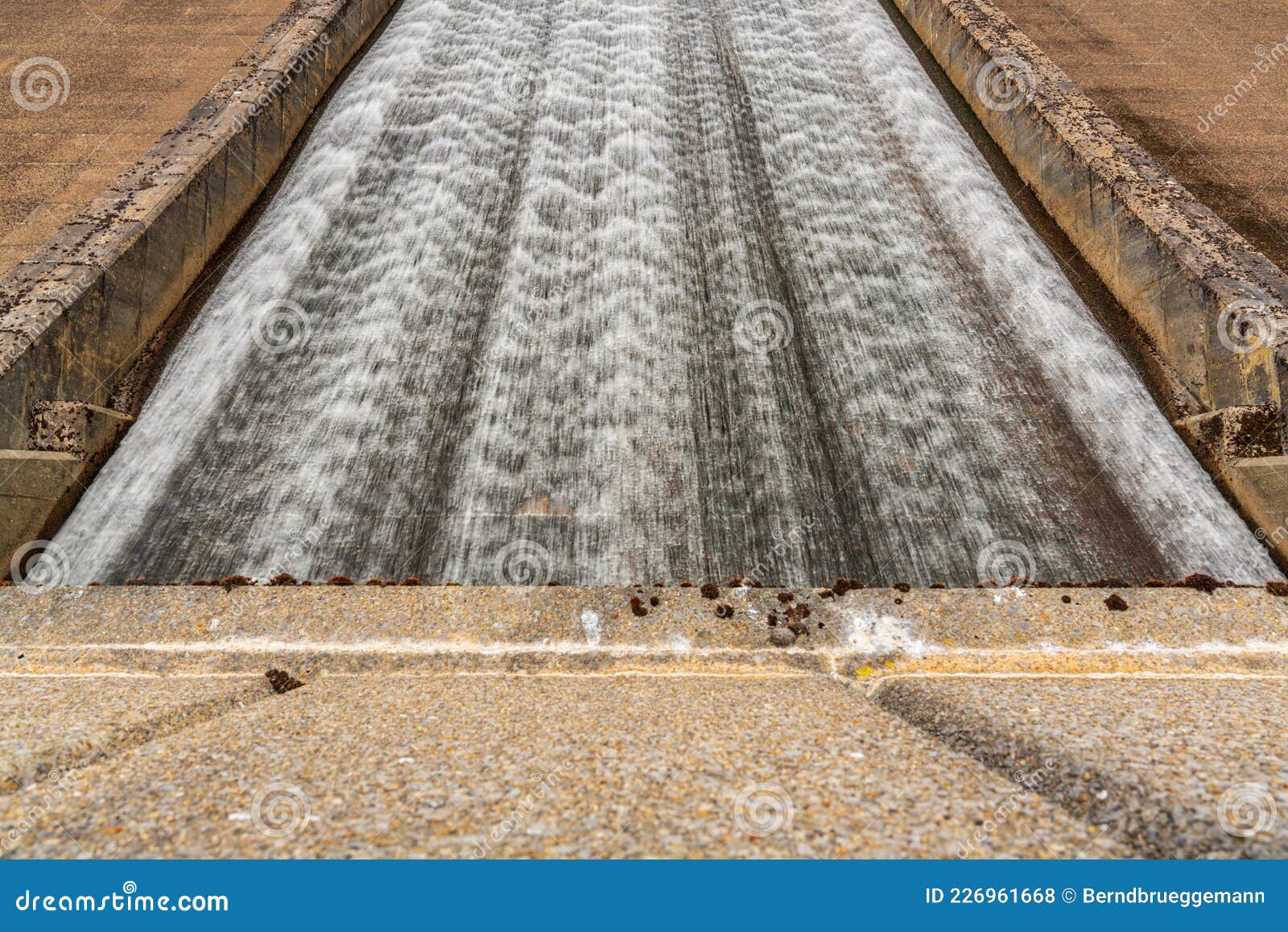 Water flowing down a dam stock photo. Image of flow - 226961668