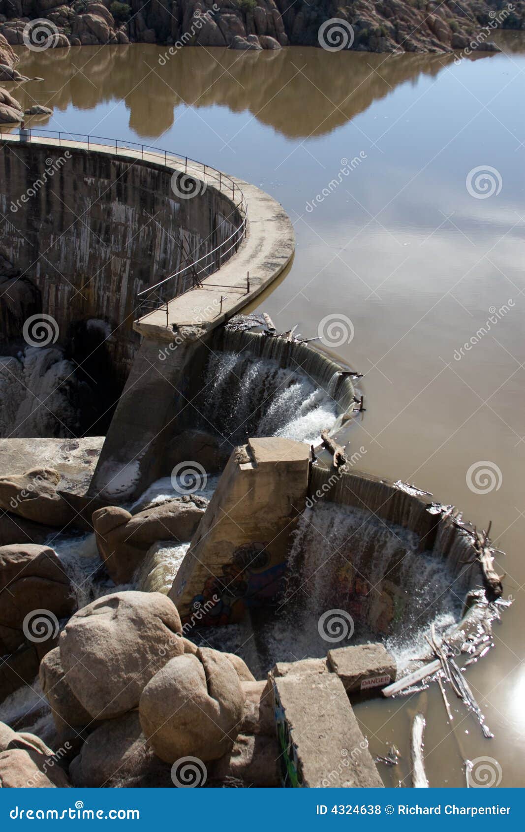 Water flowing over a dam stock photo. Image of reflections - 4324638