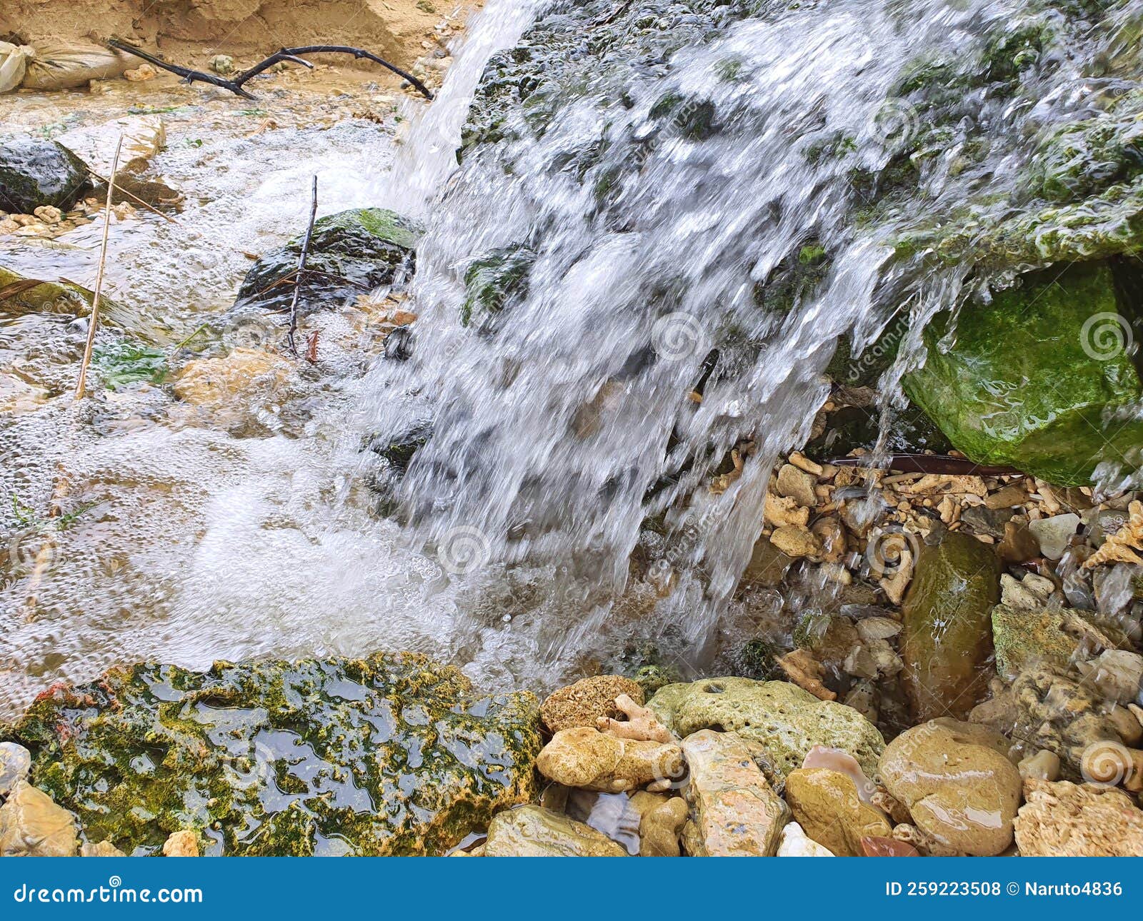 Water flowing over rocks stock photo. Image of green - 259223508