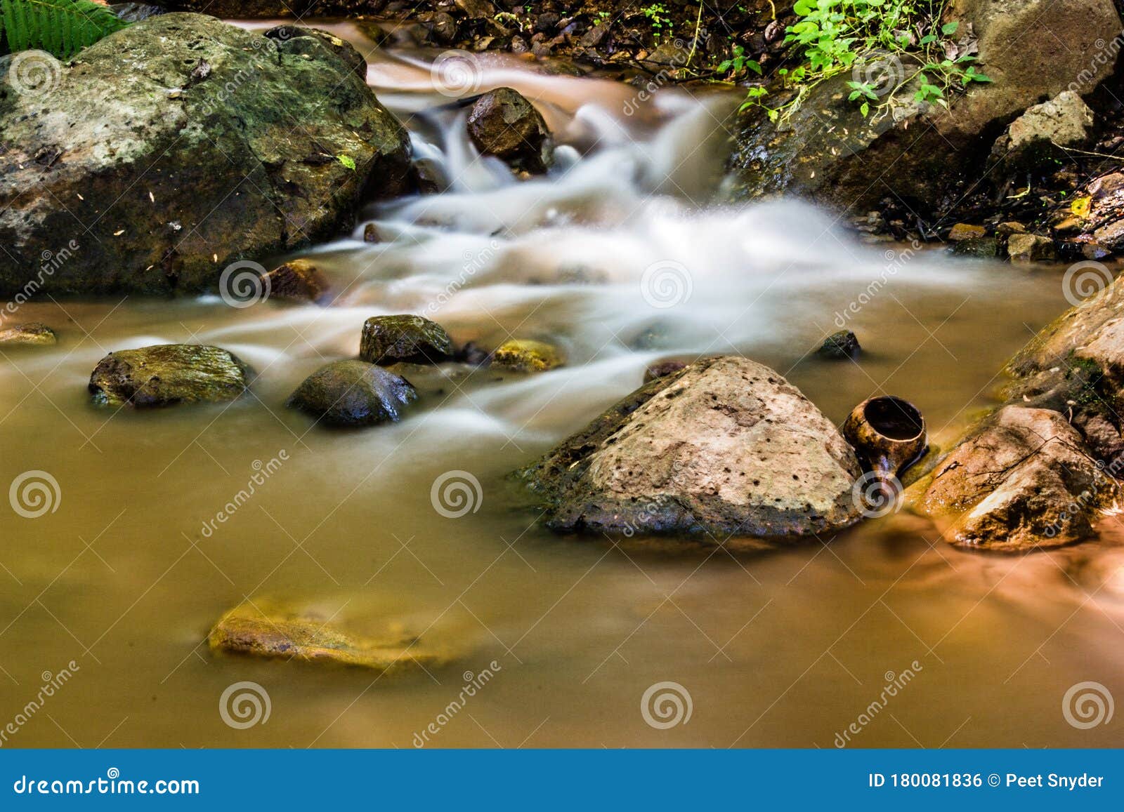 Water flowing over rocks stock photo. Image of pond - 180081836