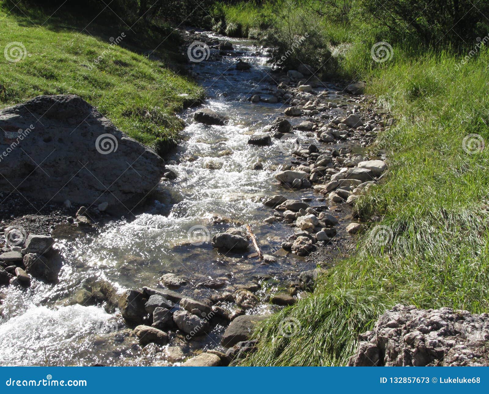 Water Flowing and Splashing Over Rocks in a Mountain River Stream Stock ...
