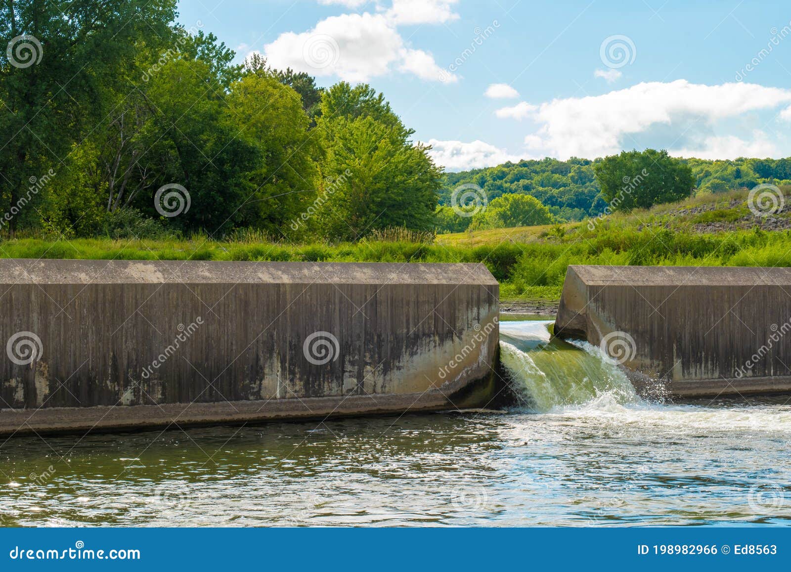 Water Flows through the Floodgate in a Concrete Dam on a River Stock ...