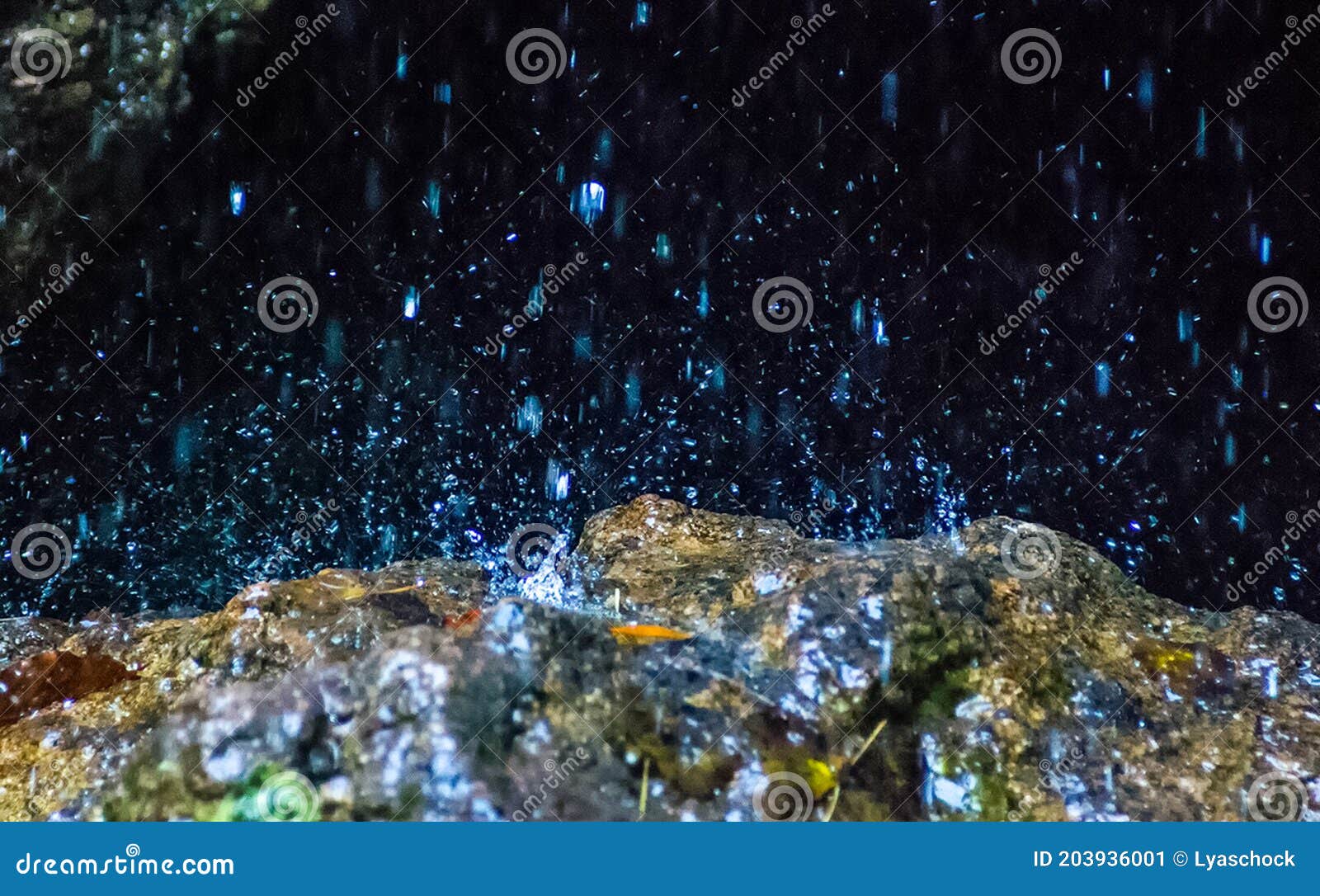 Water Flows through Rocks in the Cave. a Small Waterfall at the ...