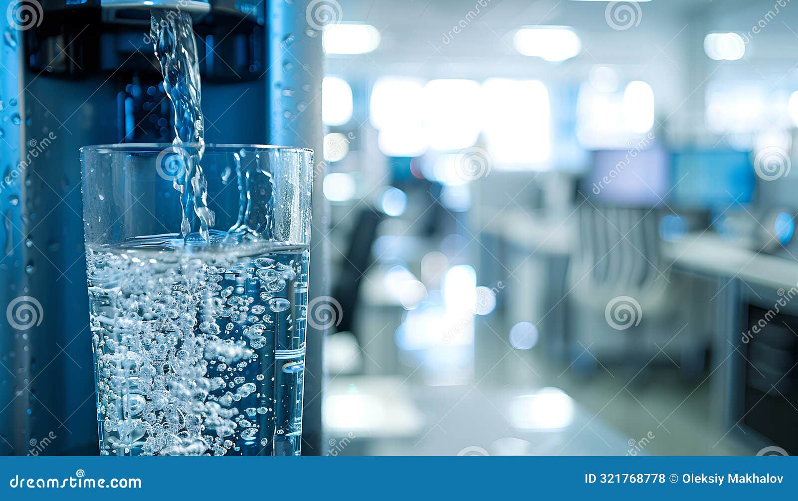 Water Flows into a Transparent Glass from a Cooler on a Blurred Office ...