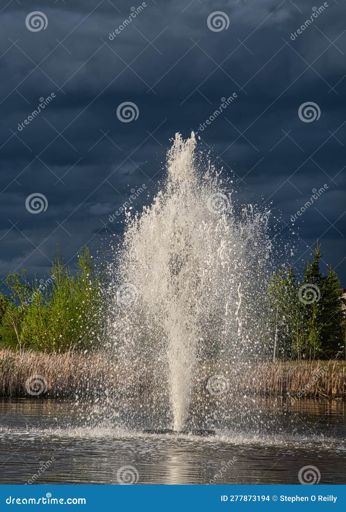 Water Fountain with Stormey Clouds in the Backround Stock Photo - Image of fountain, backround ...