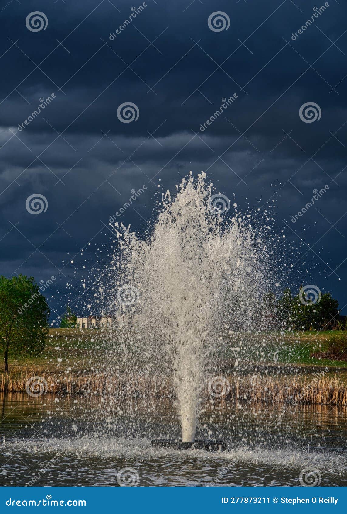 Water Fountain with Stormey Clouds in the Backround Stock Image - Image ...