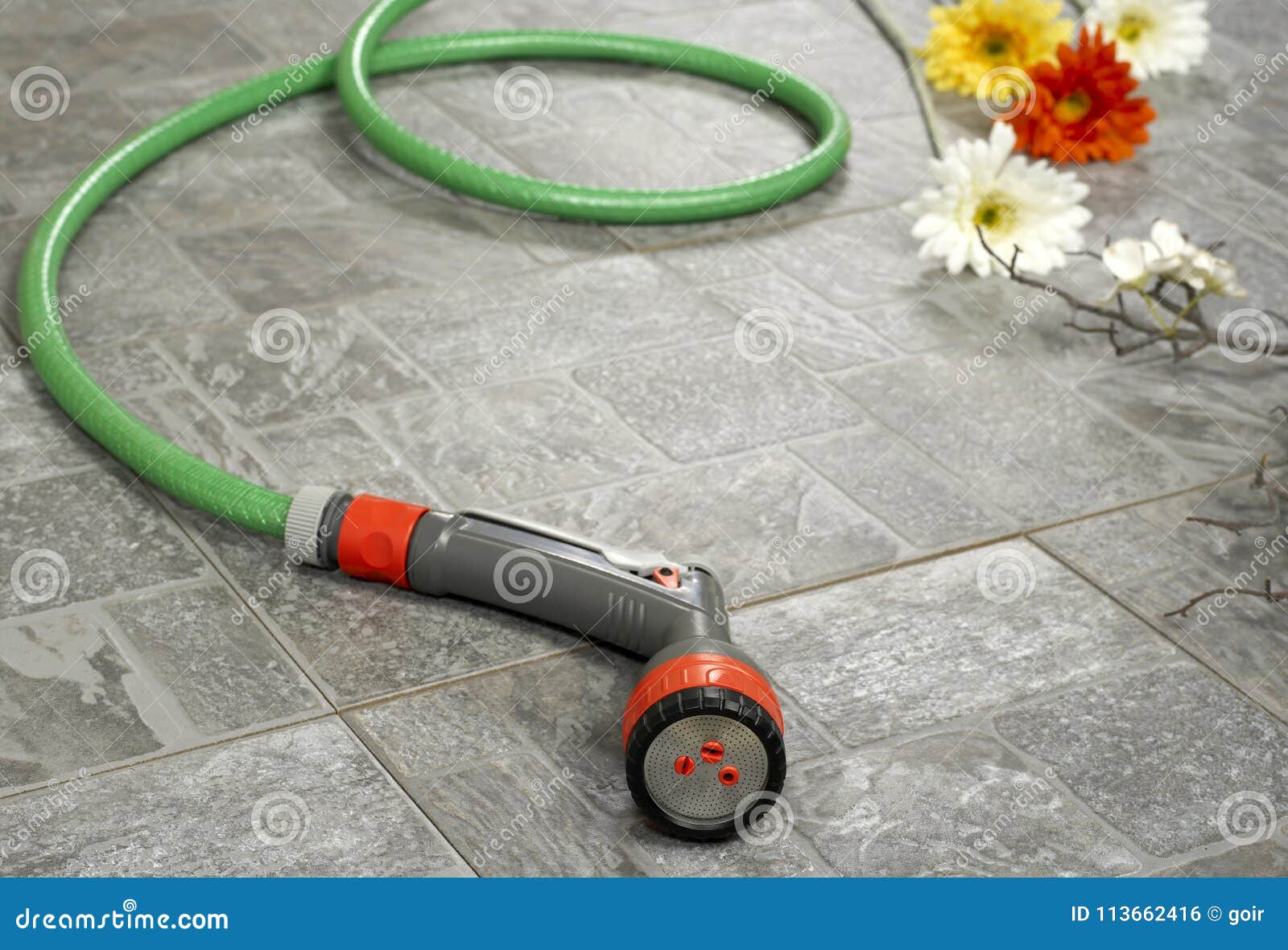 Water hose on tile floor stock photo. Image of focus - 113662416